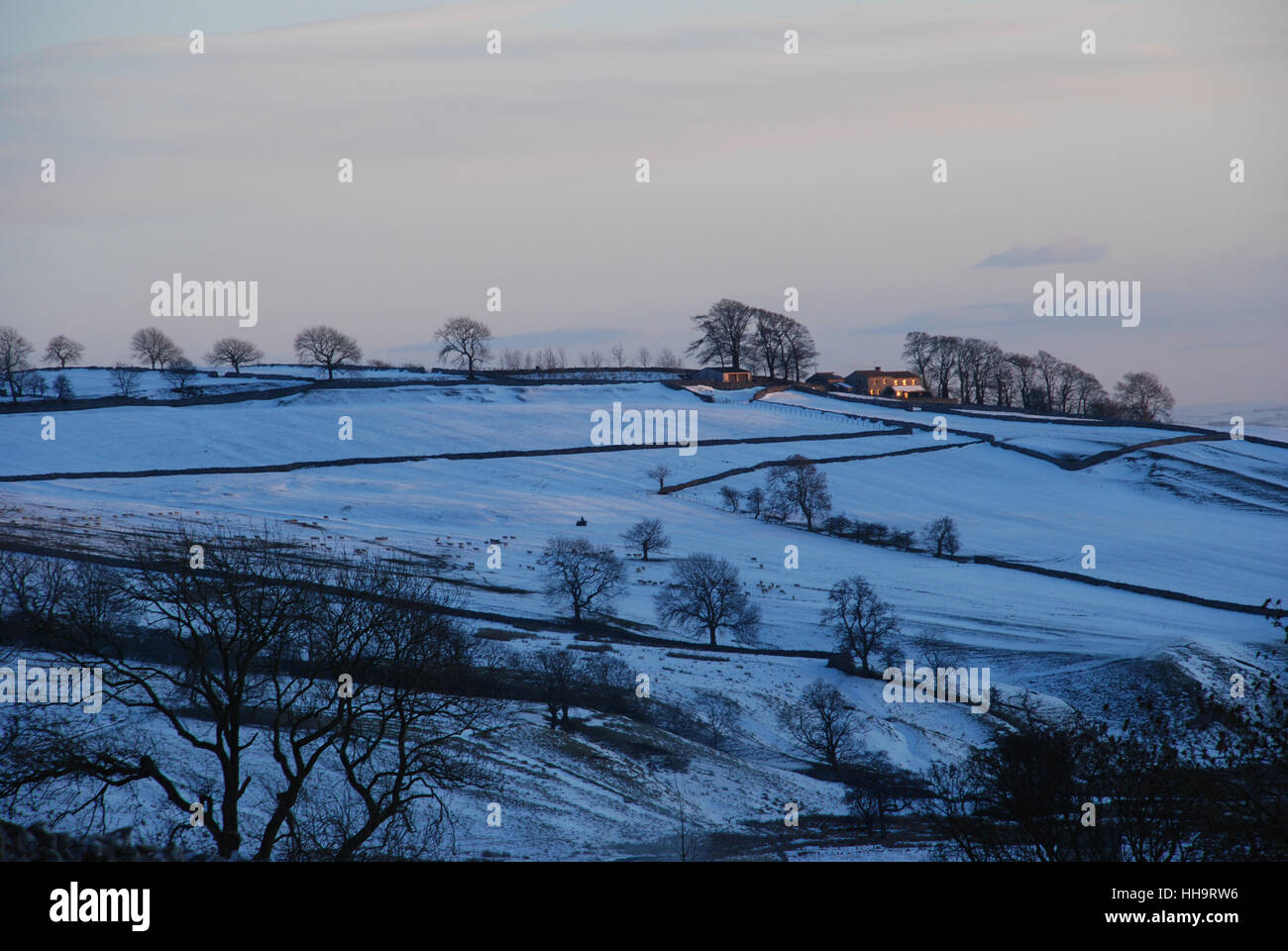 winters evening across a snowy Yorkshire landscape as the sun goes down ...