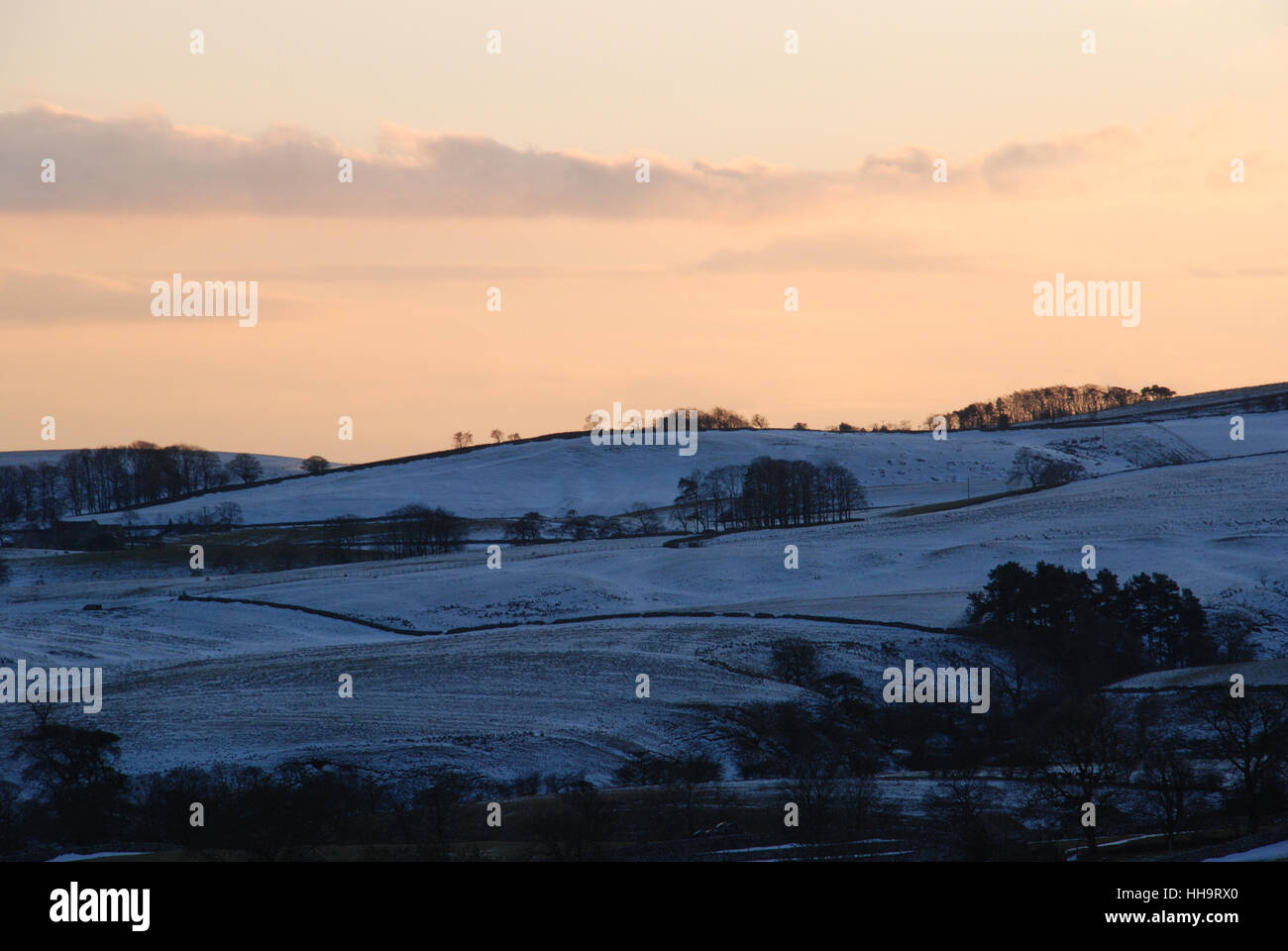 The sun setting behind a snow covered Yorkshire landscape giving a ...