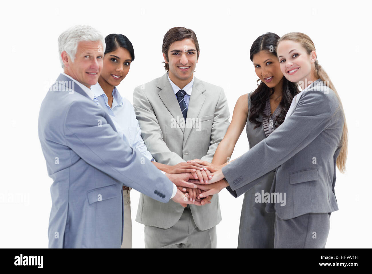 People putting their hands on each others against white background ...