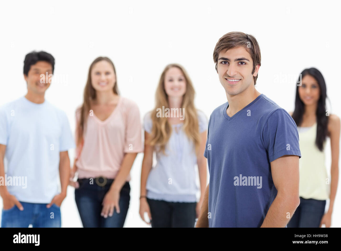 People smiling with one in foreground against white background Stock ...