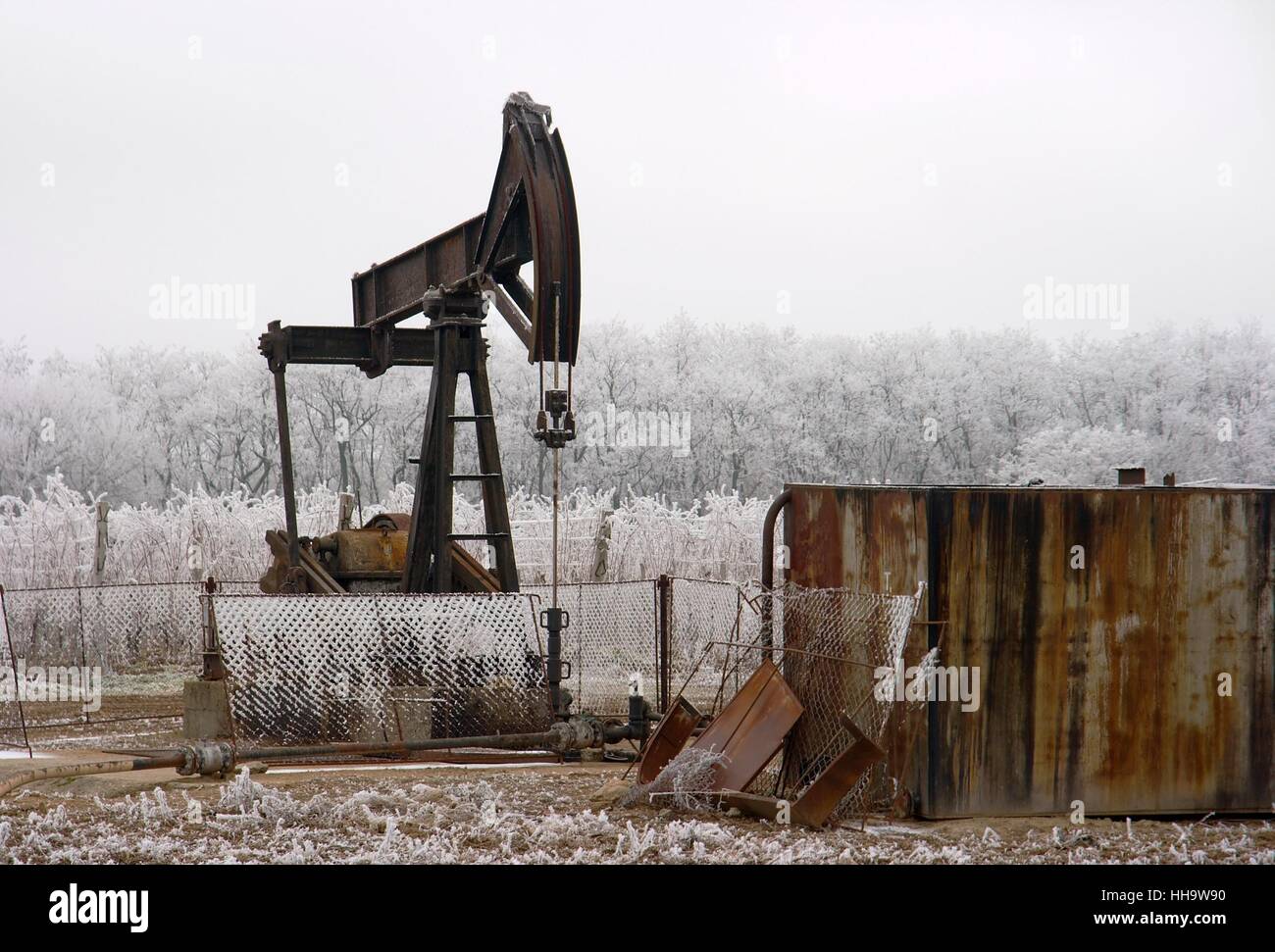 Old rusty oil well on a winter landscape Stock Photo - Alamy