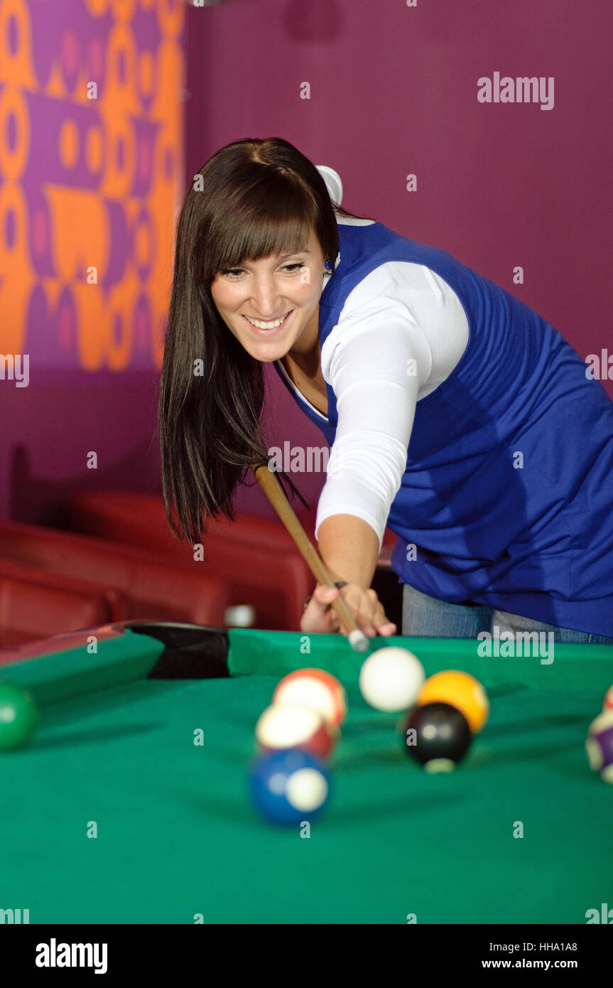 concentrated young woman playing snooker Stock Photo - Alamy