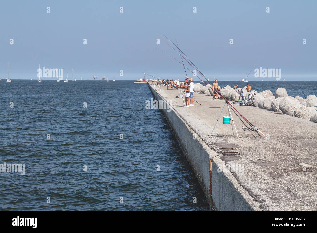Fishing from the pier or fishing wharf with fishing net and rod at ...