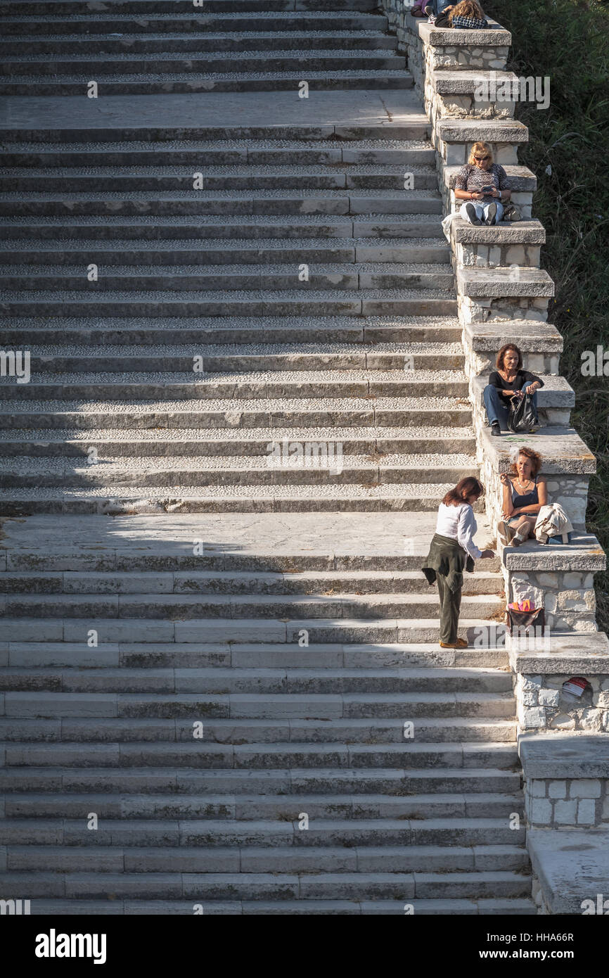 People relaxing laying on stairs in Ancona Italy Stock Photo - Alamy