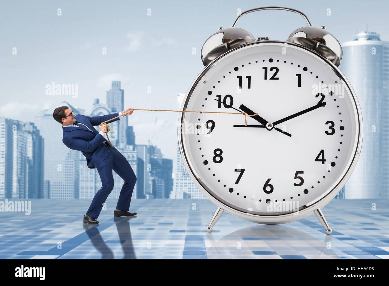 Businessman pulling clock in time management concept Stock Photo - Alamy