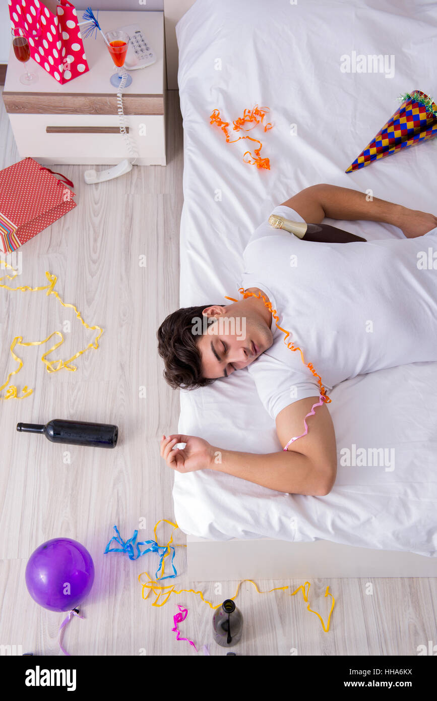 Man at home after heavy partying Stock Photo - Alamy