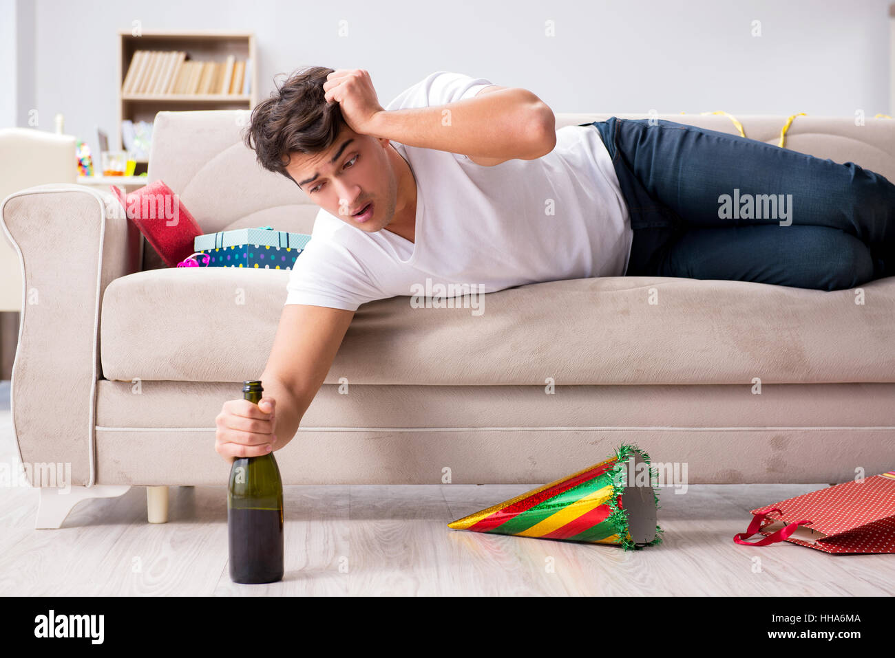 Man at home after heavy partying Stock Photo - Alamy