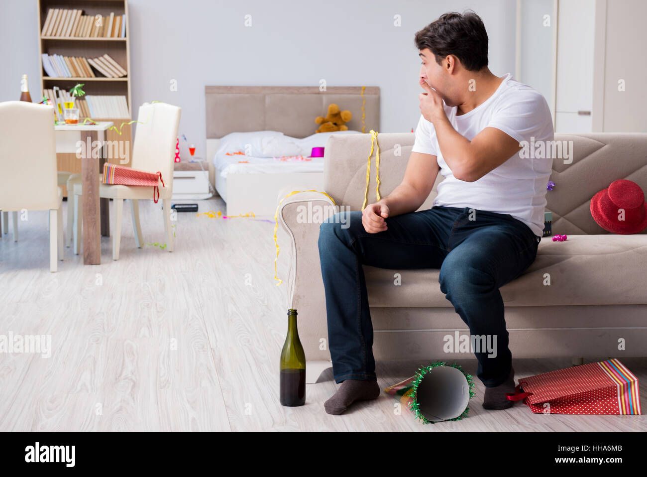 Man at home after heavy partying Stock Photo - Alamy