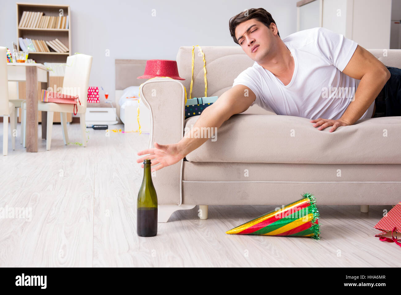 Man at home after heavy partying Stock Photo - Alamy