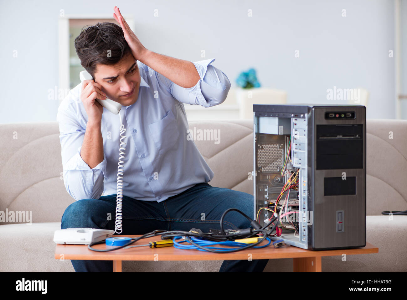 Angry customer trying to repair computer with phone support Stock Photo ...