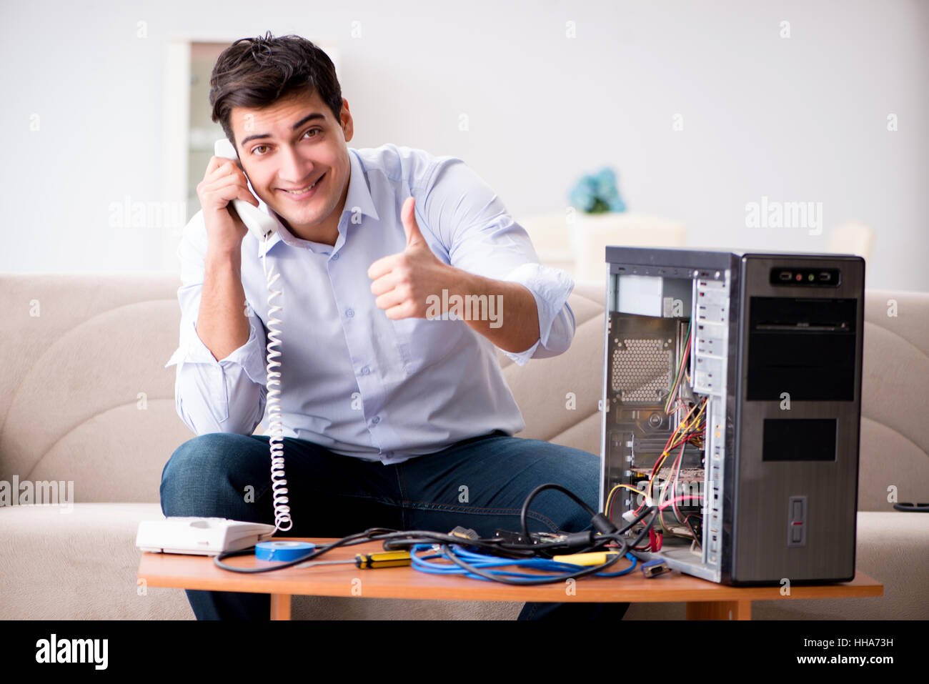 Happy customer resolving his computer problem Stock Photo - Alamy