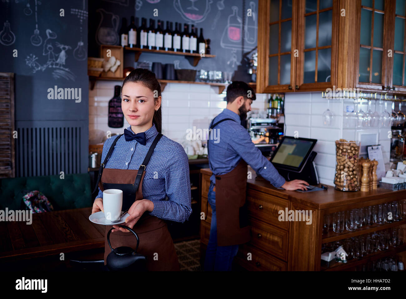 Waitress, a waiter working at cafe bar restaurant Stock Photo - Alamy