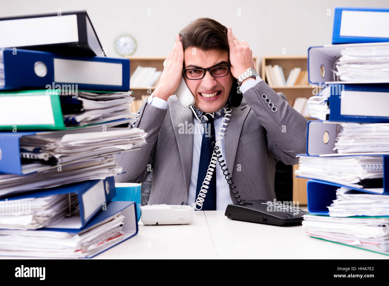 Busy businessman under stress due to excessive work Stock Photo - Alamy