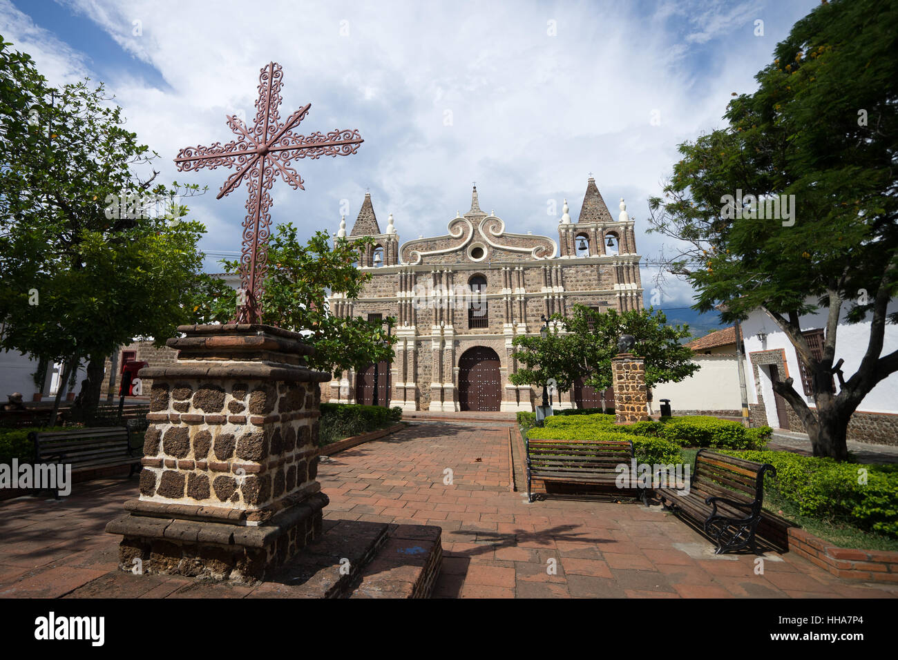 Large cross in front the colonial church within a small park in Santa ...