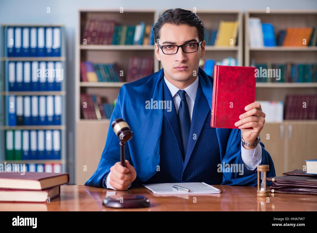 Handsome judge with gavel sitting in courtroom Stock Photo - Alamy