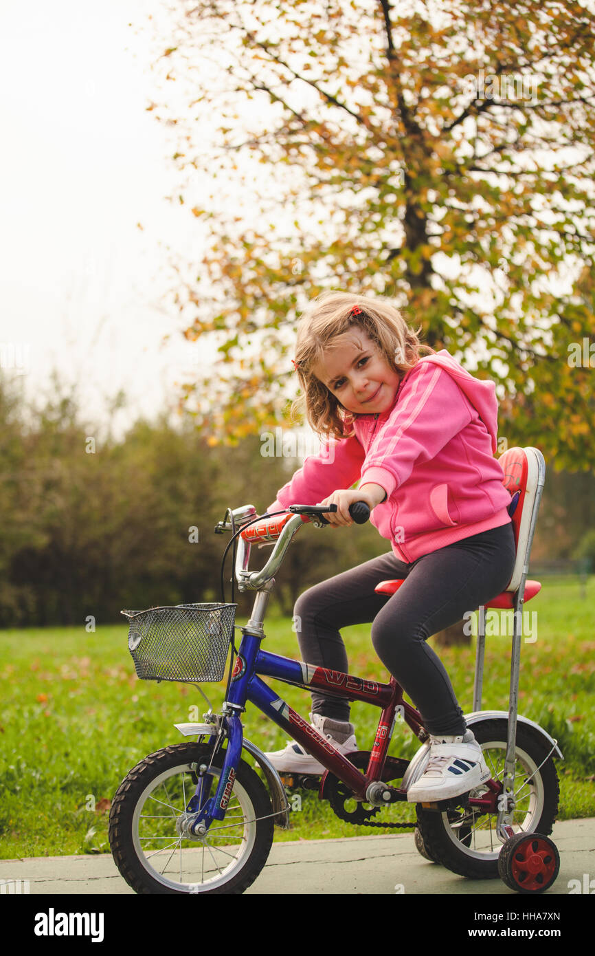 young girl on bike in the park Stock Photo - Alamy