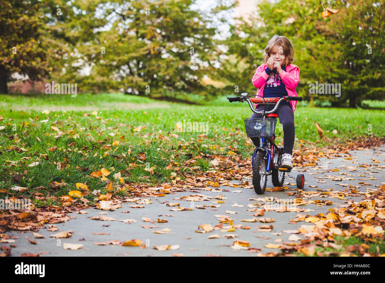 Young girl on a bike in the park Stock Photo - Alamy