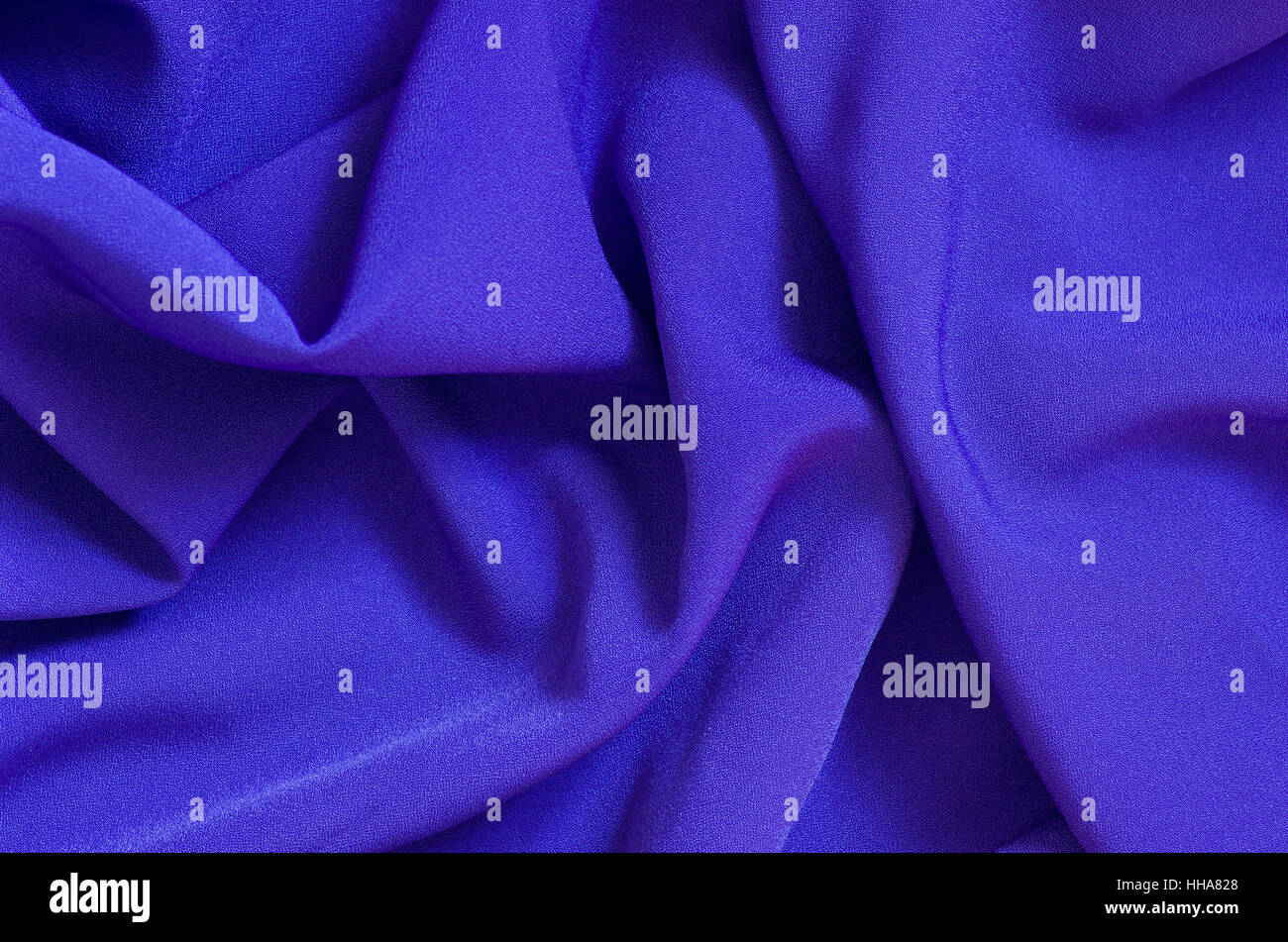 Blue glossy material draped in a pattern forming background Stock Photo ...