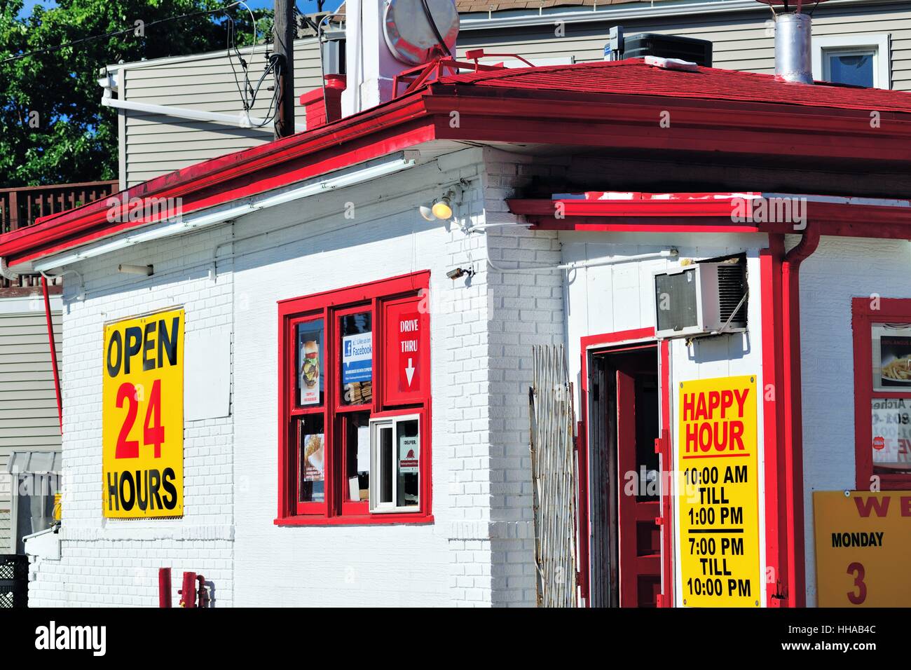 A small, colorfully trimmed drive-through restaurant establishment with ...