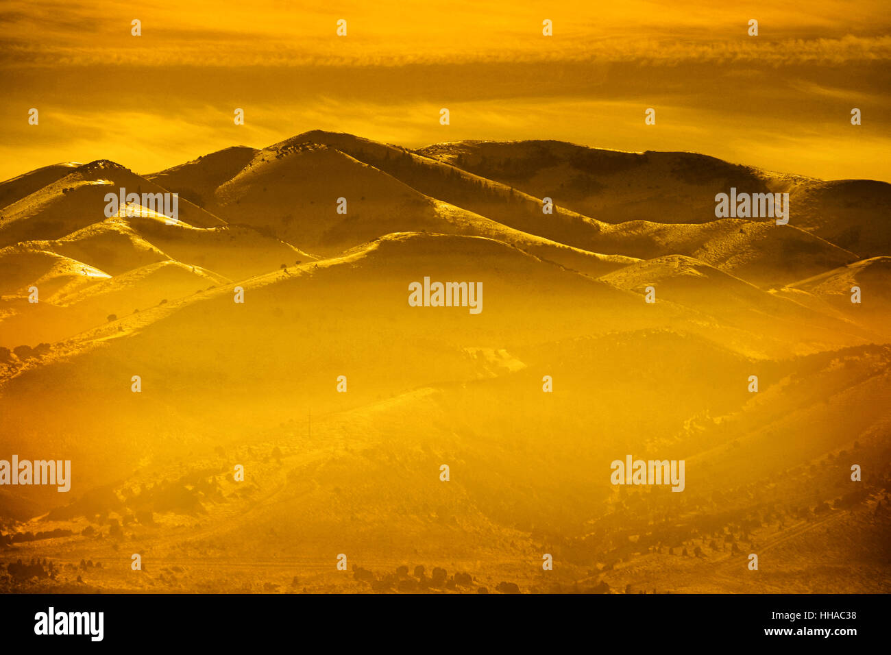 Misty sunlight mountains dusty landscape Stock Photo - Alamy