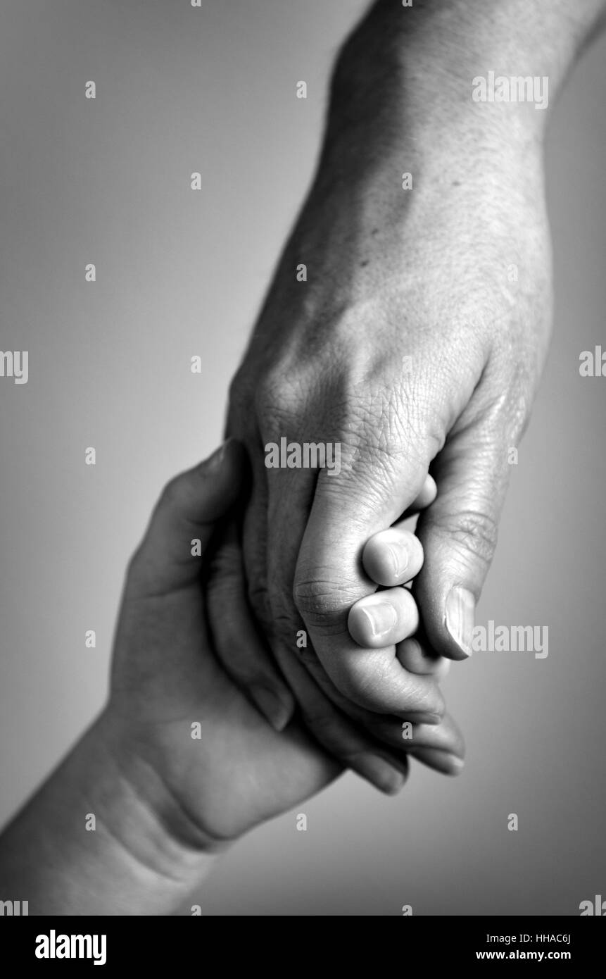 Adult holding the hand of a child showing support and love Stock Photo ...