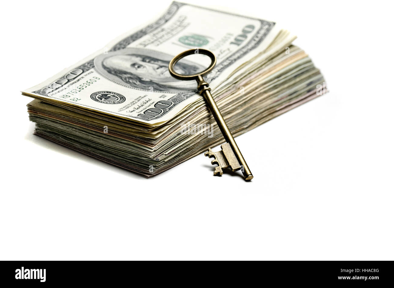 Wealth and riches represented by cash money and a key Stock Photo - Alamy