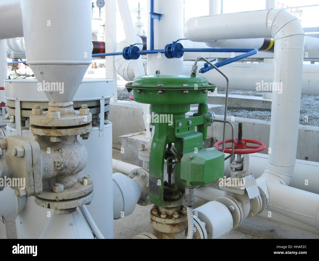 Green pneumatic valve on the pipeline. The equipment of the oil plant ...