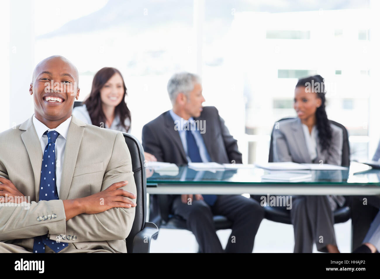 Young man crossing arms laughing hi-res stock photography and images ...