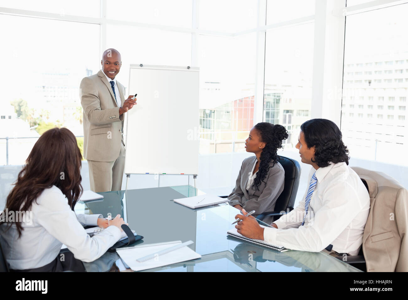 Executive giving a presentation in front of his co-workers Stock Photo ...