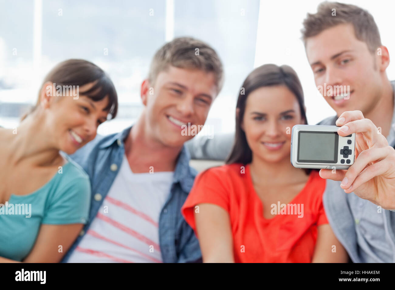 A focused shot on the camera as a group use it to take a photo of ...