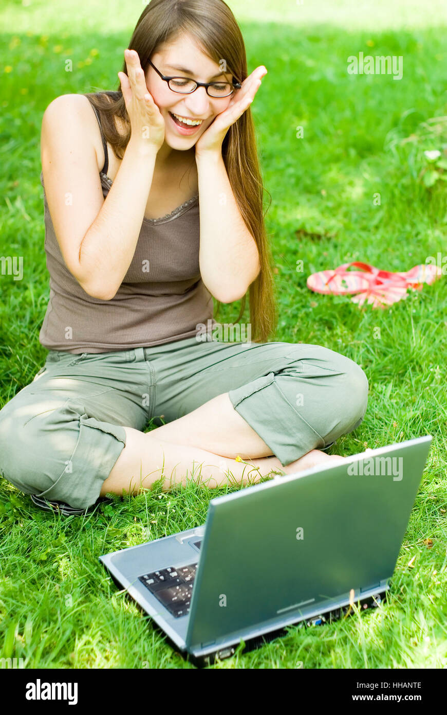 portrait of happy young woman surfing the internet outdoors on her ...