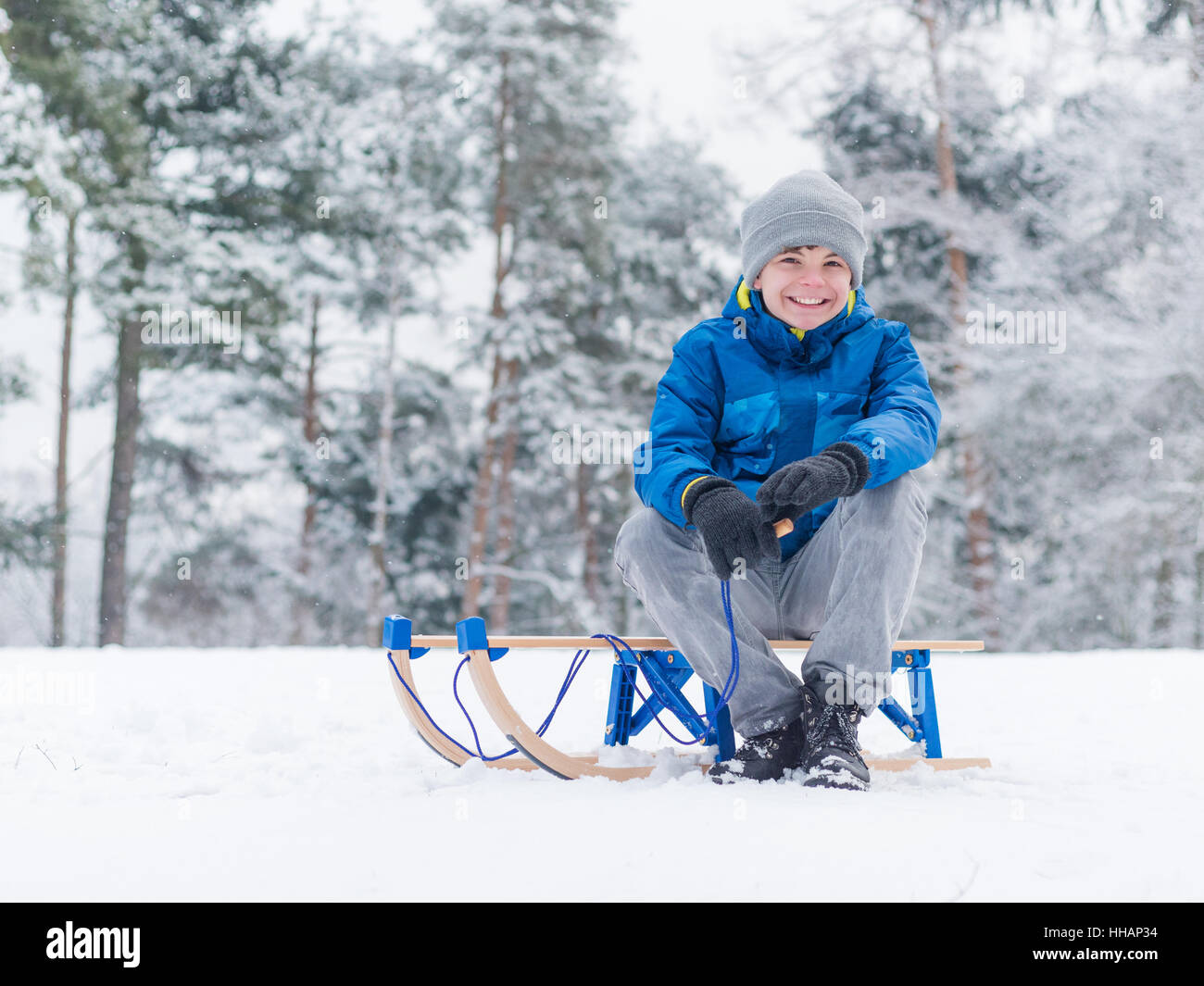 Child play in snow with sled Stock Photo - Alamy