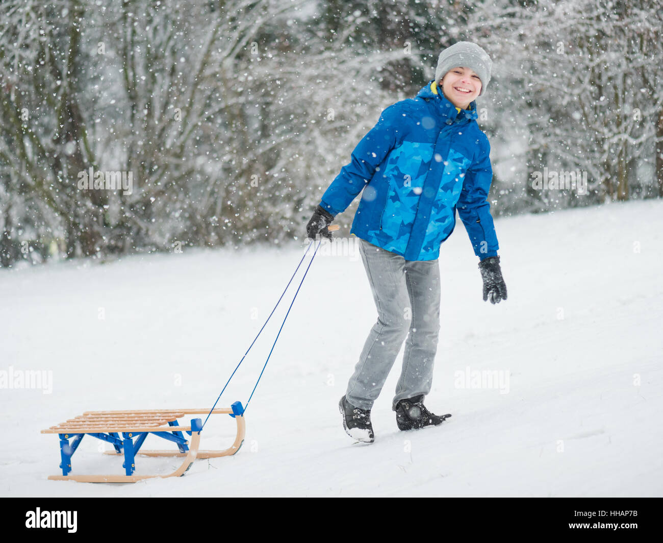 Child play in snow with sled Stock Photo - Alamy