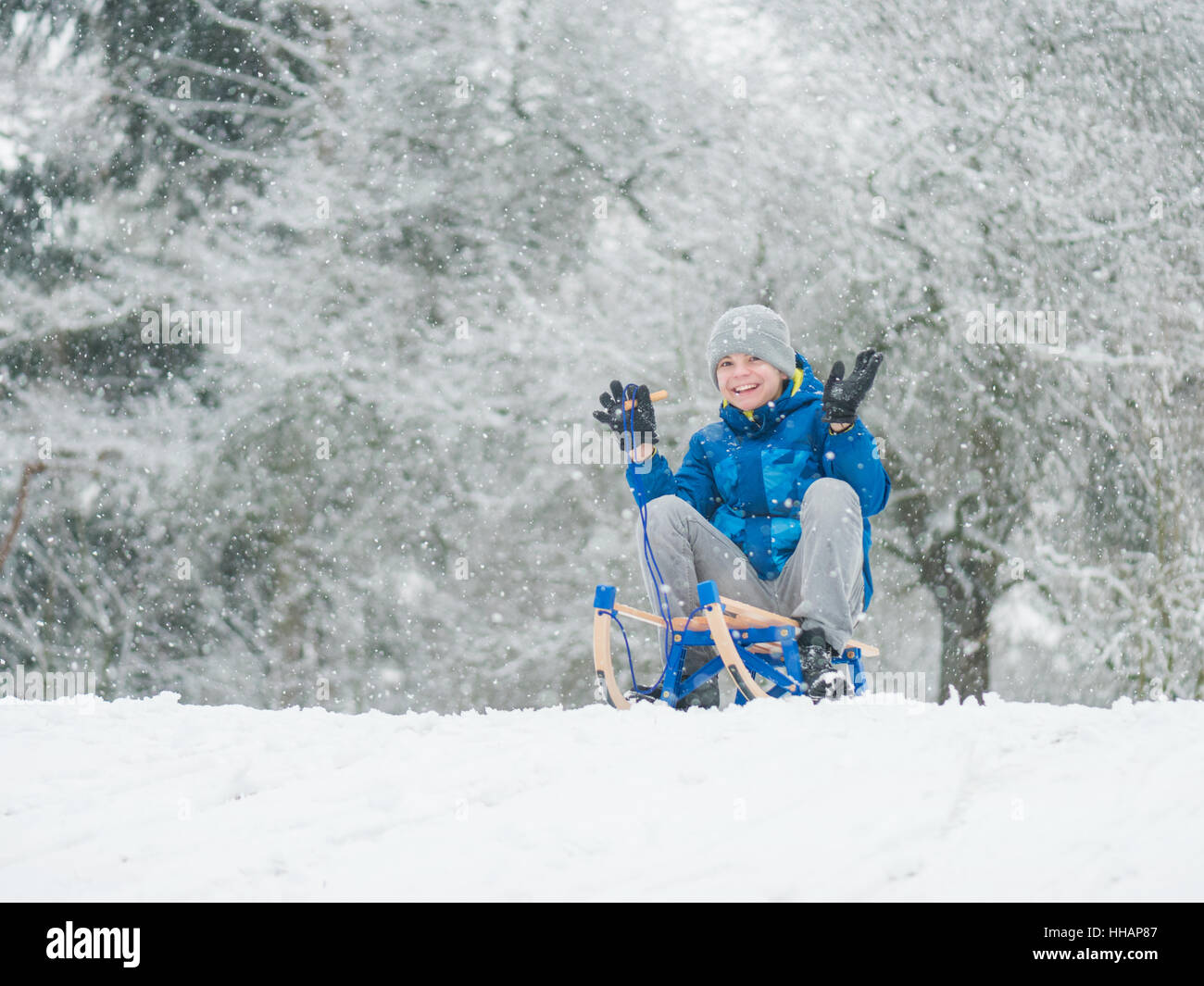 Child play in snow with sled Stock Photo - Alamy