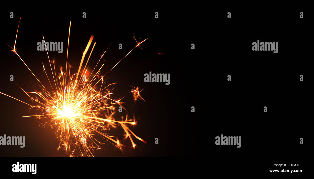 a burning sparkler on black Stock Photo - Alamy
