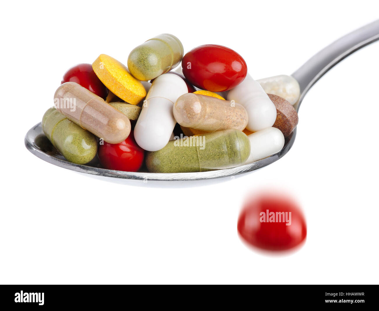 spoon overflowing with tablets Stock Photo - Alamy