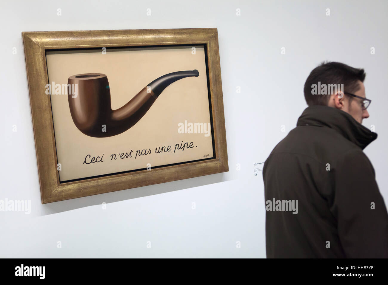 Visitor in front of the painting 'La trahison des images' ('The ...