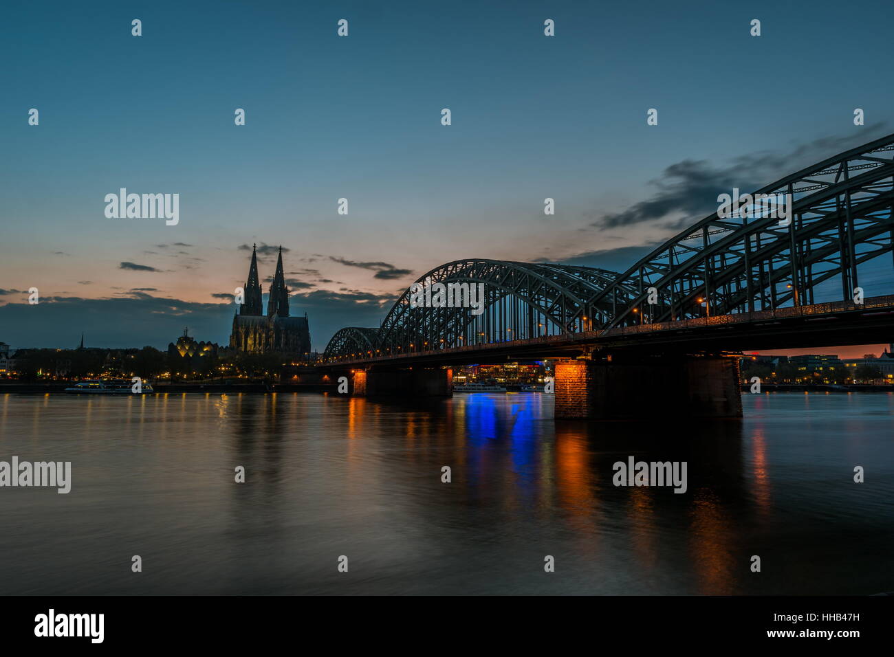 Sunset view of Cologne Cathedral and Hohenzollern Bridge Stock Photo ...