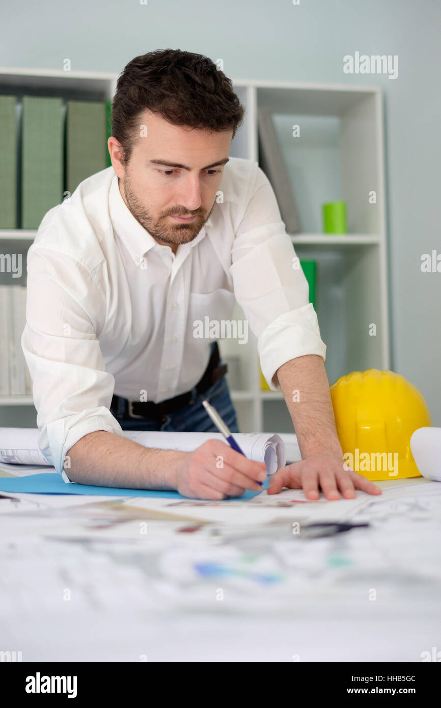 Architect working on his projects papers in the office Stock Photo - Alamy