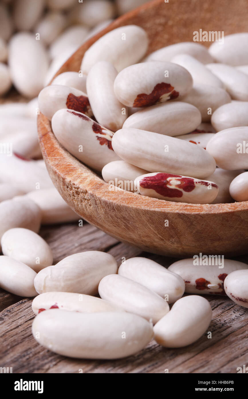 white beans with red spots in the wooden spoon. closeup vertical Stock ...