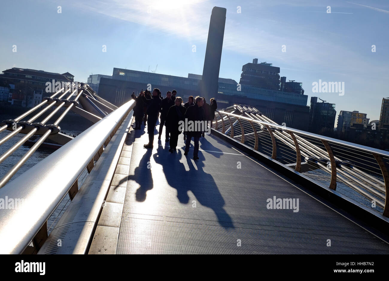 people on the millennium bridge looking towards tate modern, london ...