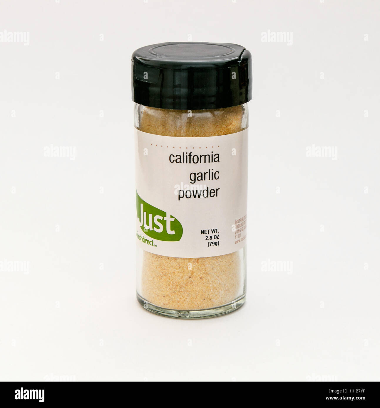 A bottle of garlic powder by Fresh Direct is seen against white ...