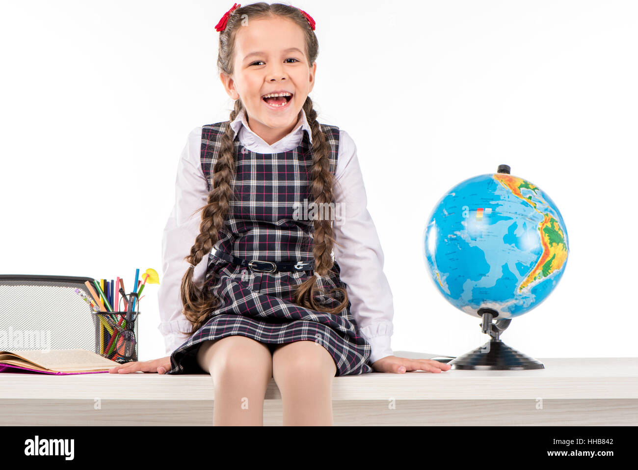 Happy schoolgirl sitting on table hi-res stock photography and images ...