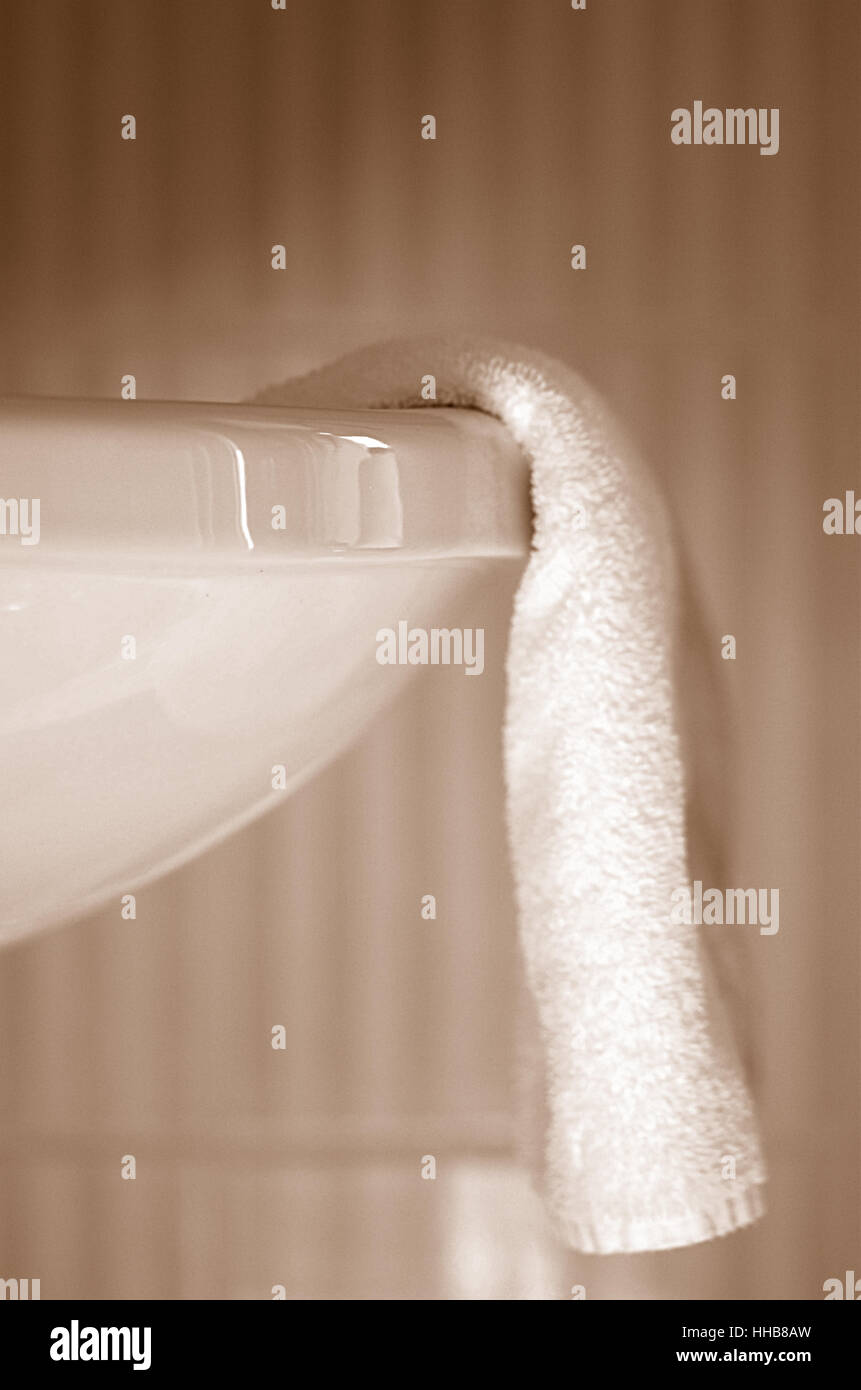 White towel draped over white porcelain sink Stock Photo - Alamy