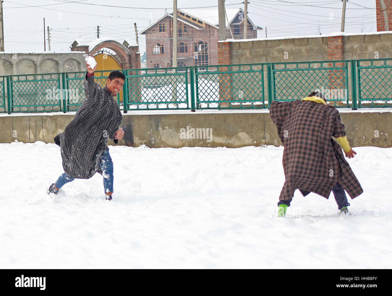 Srinagar, India. 18th Jan, 2017. Children throwing snowballs to each ...