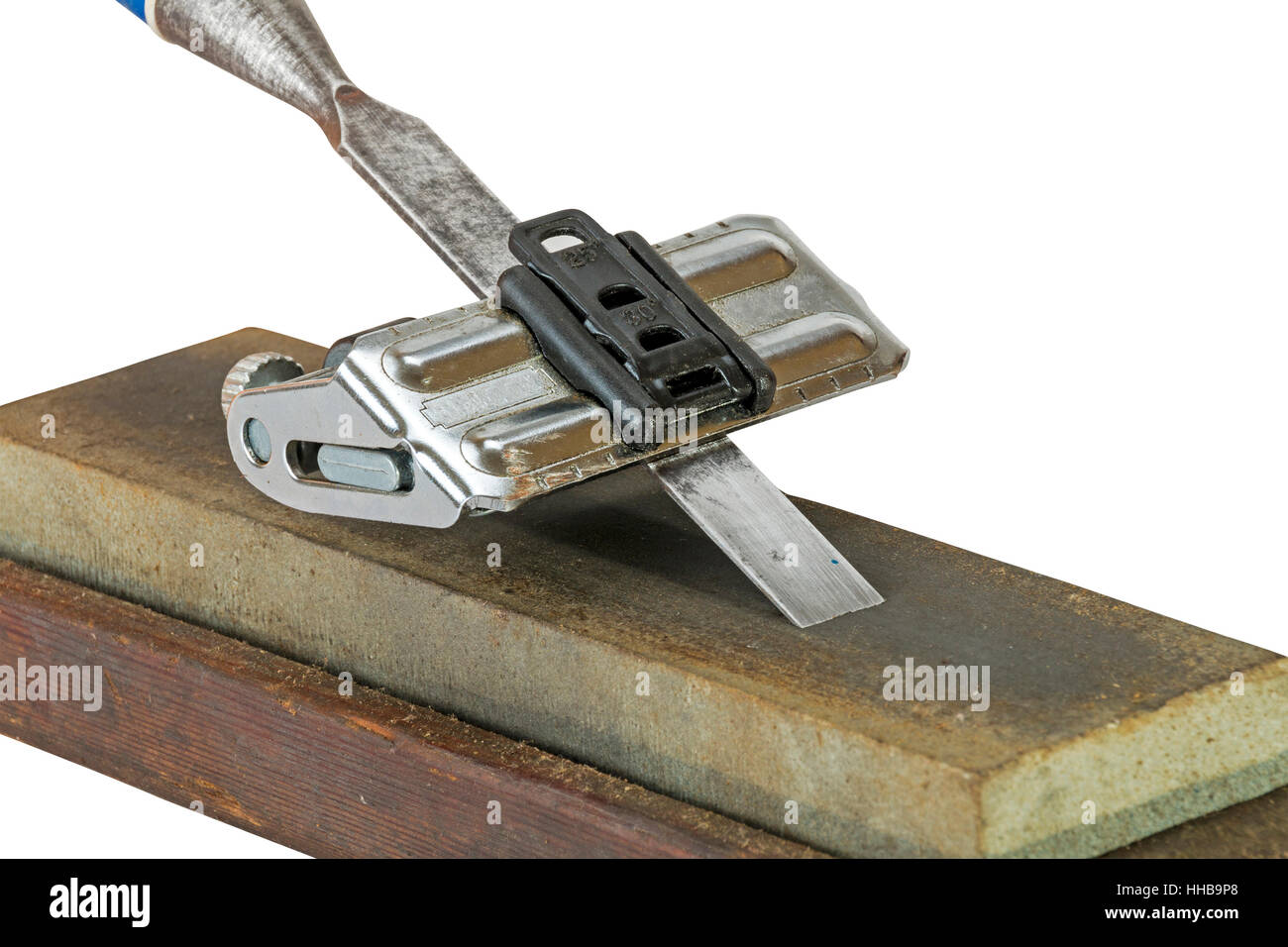 Close up studio shot of chisel clamped in angle guide jig resting on ...