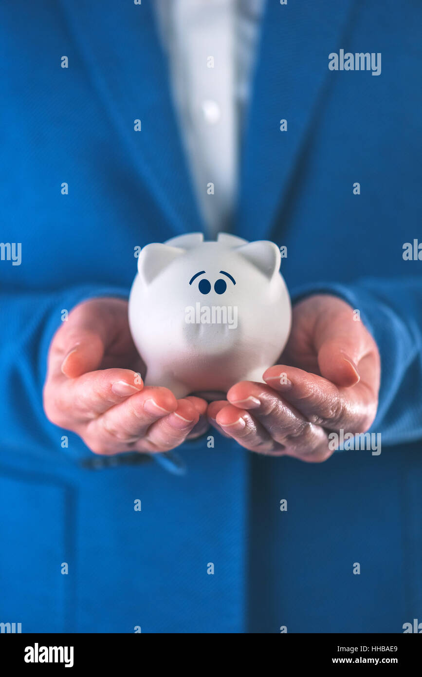 Worried and afraid piggy coin bank in hands of professional ...