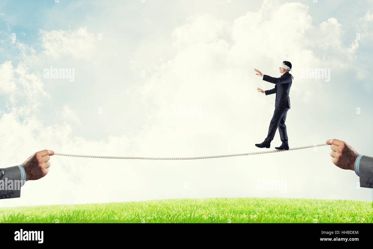 Business concept of risk support and assistance with man balancing on ...