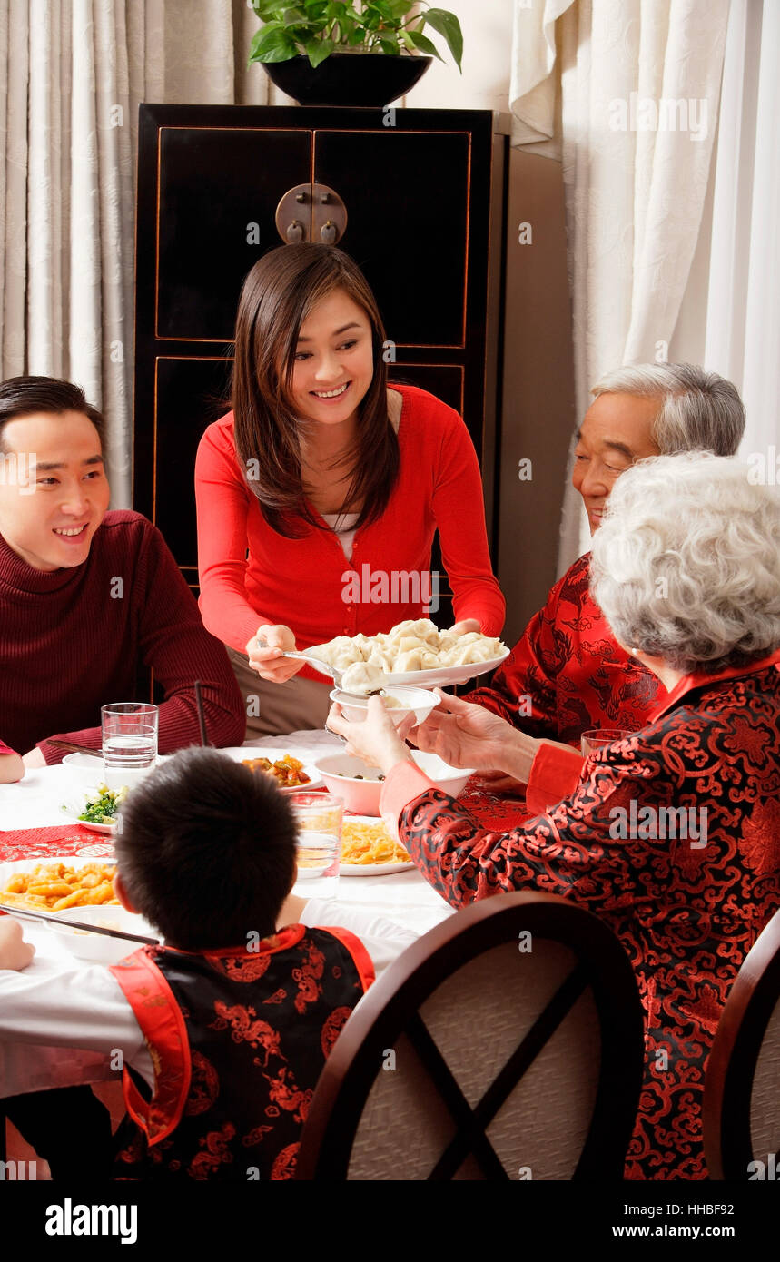 Young woman dishing food Stock Photo - Alamy