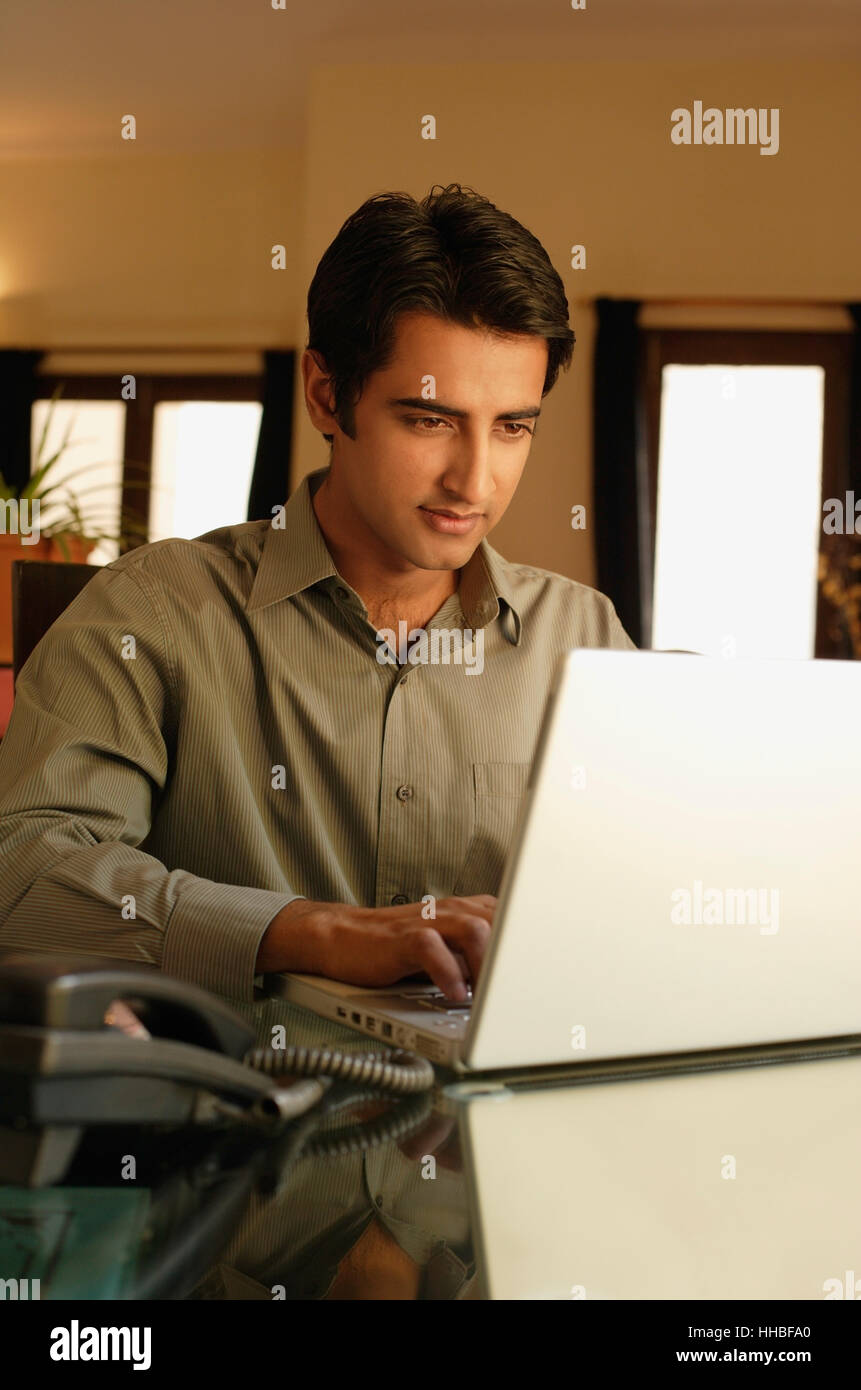 man working at laptop Stock Photo - Alamy